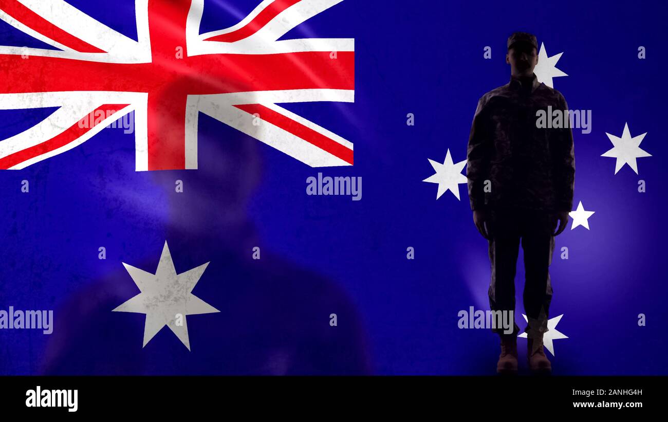 Australian soldier silhouette standing against national flag, proud ...