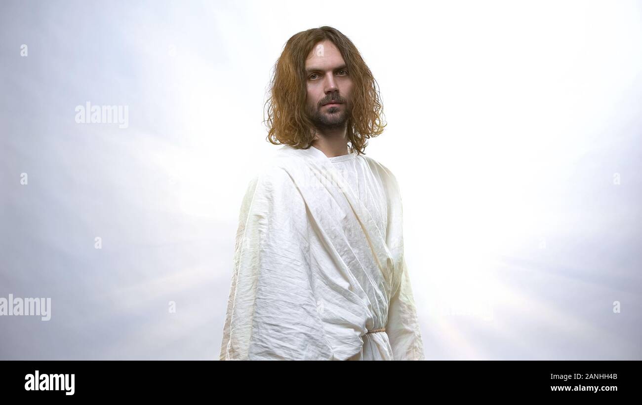 Jesus looking at camera on shiny background, looking with compassion ...