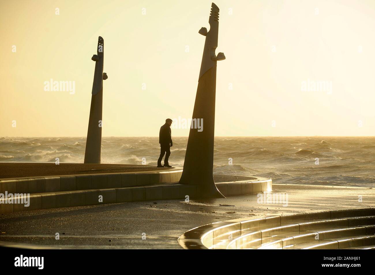 Man gets close to the sea during high tide and storm conditions at ...