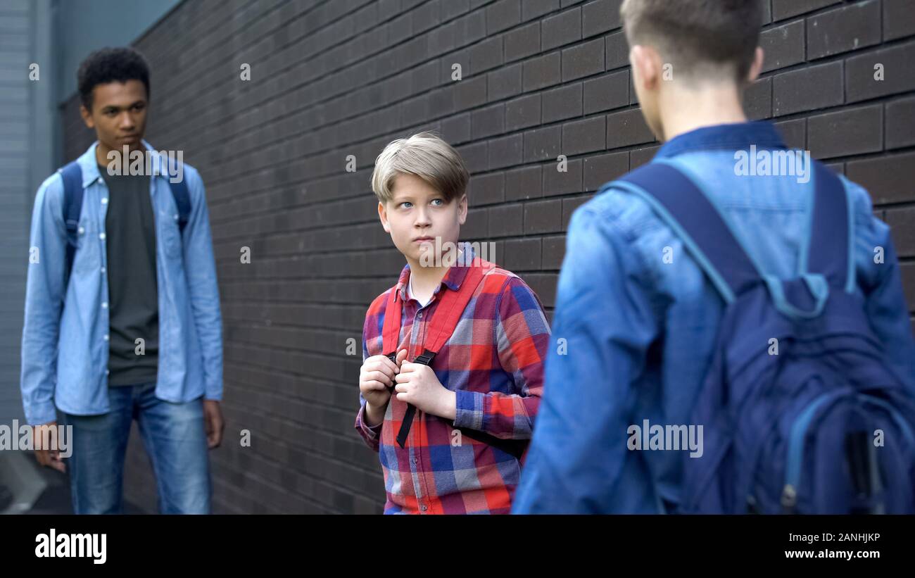 Cruel teenagers threatening younger boy, physical intimidation, school ...