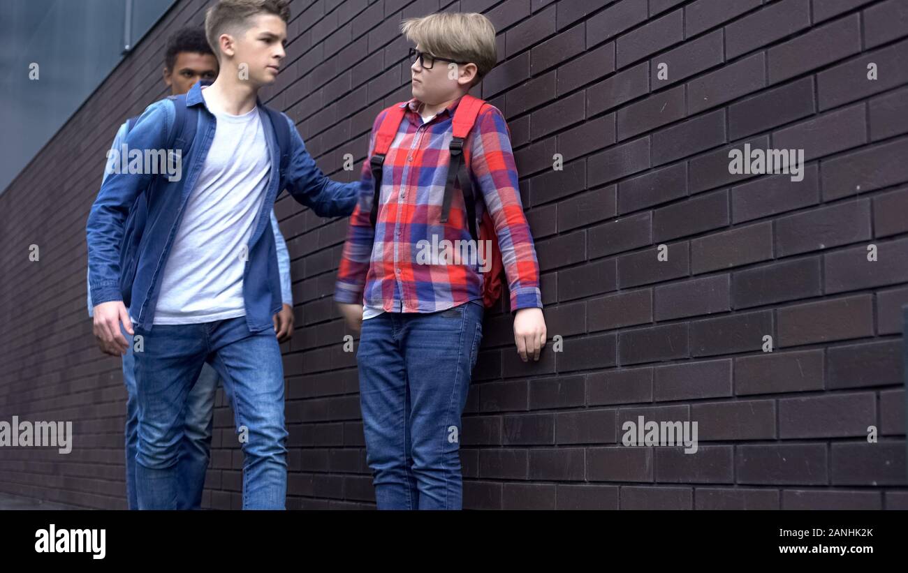 Senior students pushing and punching boy in school backyard, bullying ...