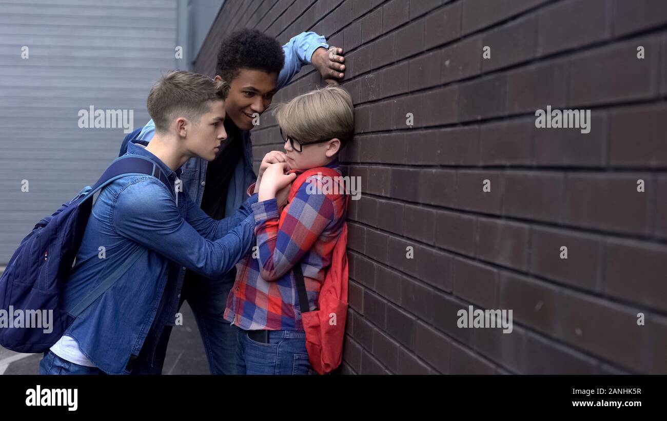 Aggressive students bullying classmate in school backyard, children ...