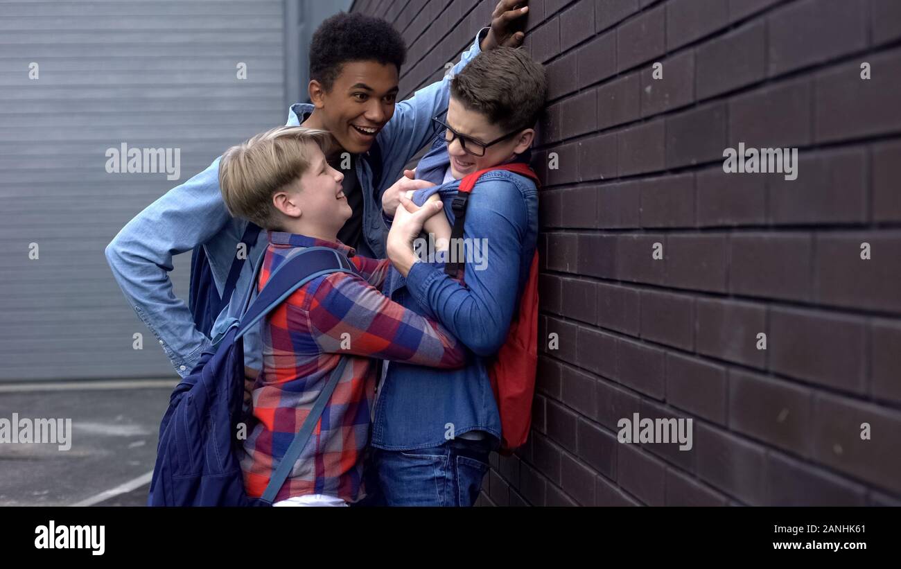 Small schoolboy bullying taller student to assert power, self ...