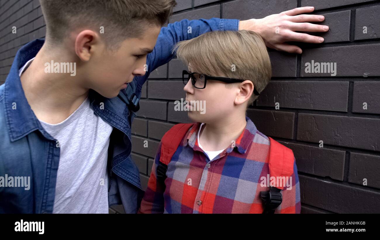 Bully boy threatening classmate pushing to wall, psychological abuse ...