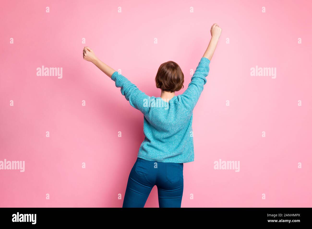 Back behind rear view photo of glad positive lucky girl raising hands ...