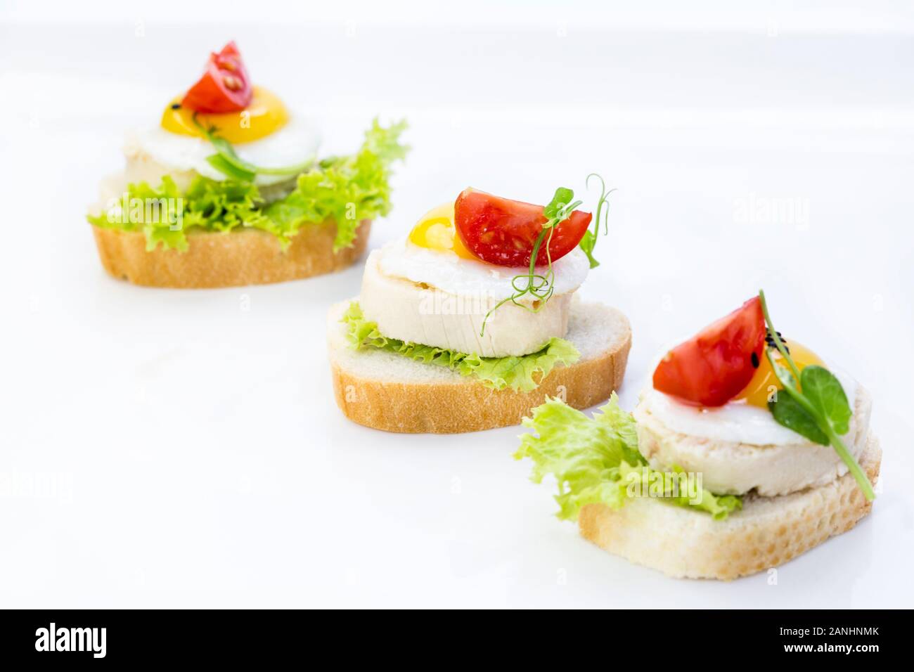 Snacks and canapes on the banquet table, closeup shot on a white ...
