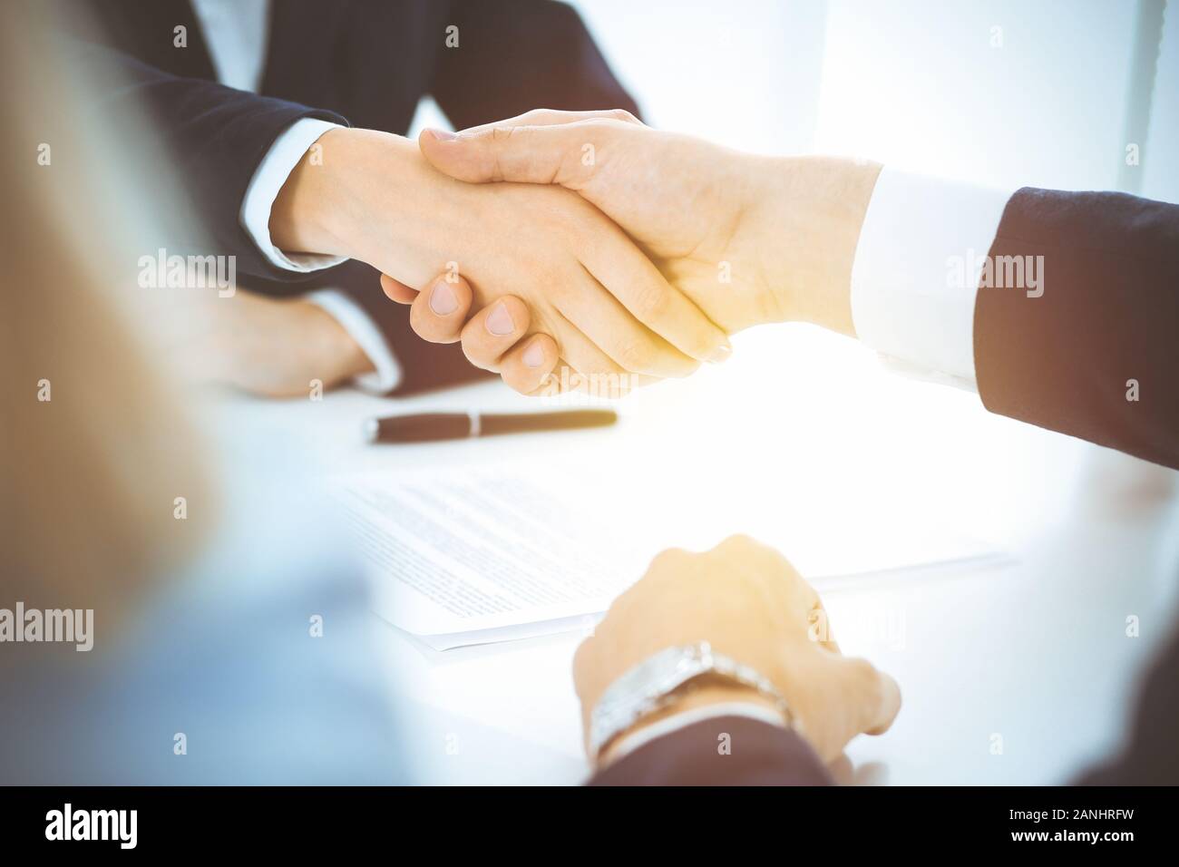 Business people shaking hands finishing up meeting or negotiation in ...