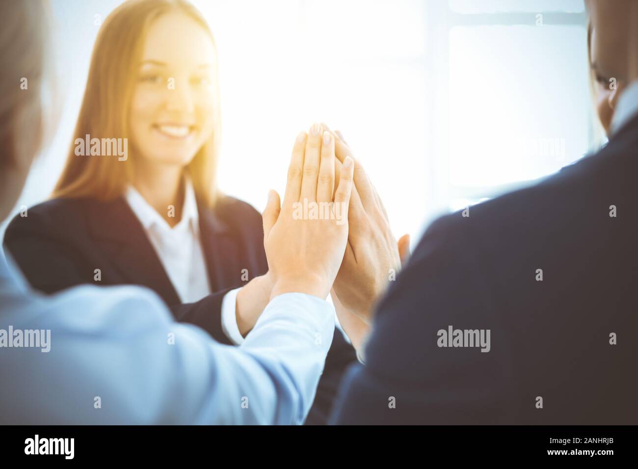 Business people happy showing teamwork and giving five showing unity ...