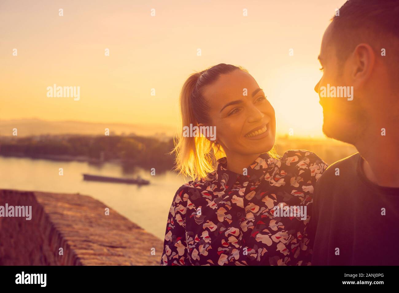 romantic couple at sunset. Young couple is enjoying sunset in the city ...