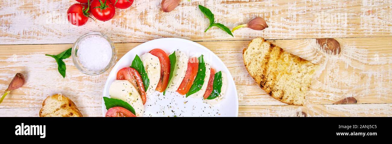 Banner with Italian caprese salad with sliced tomatoes, mozzarella ...