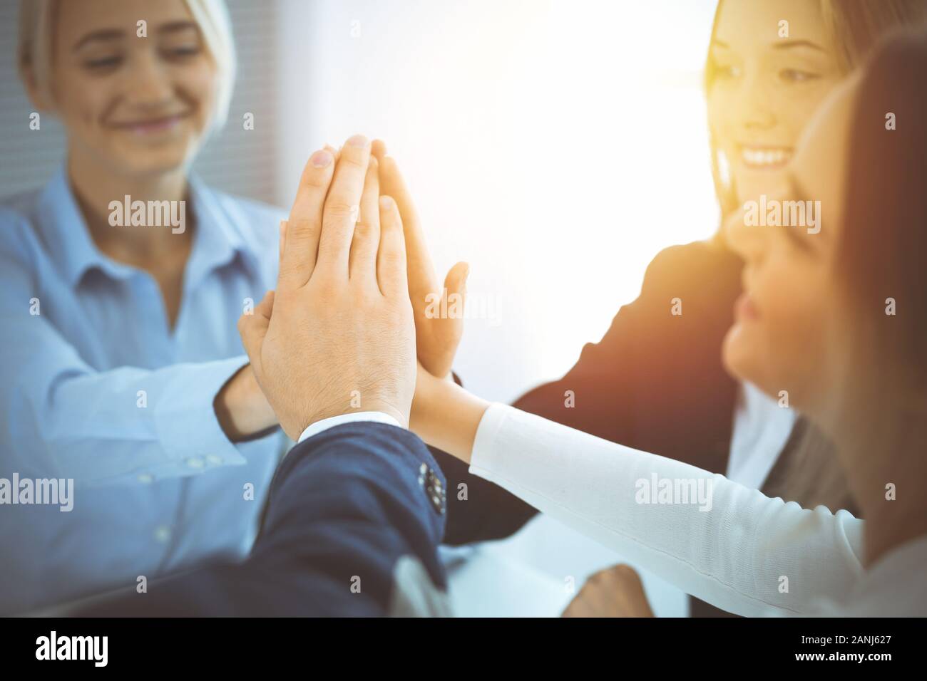 Business people happy showing teamwork and giving five showing unity ...
