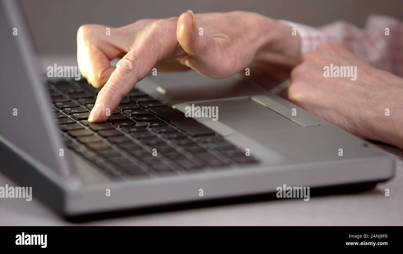 Aged woman texting message on laptop, studying modern technologies ...