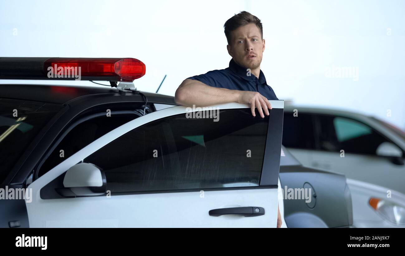 Confident cop getting out from car, going to crime scene, patrolling ...