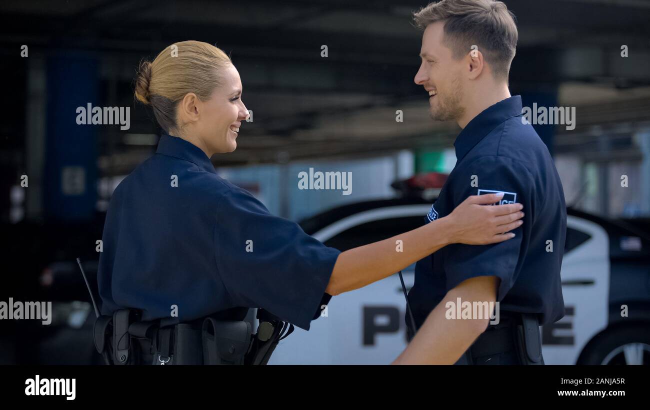 Police mates greeting each other standing near patrol car, ready to ...