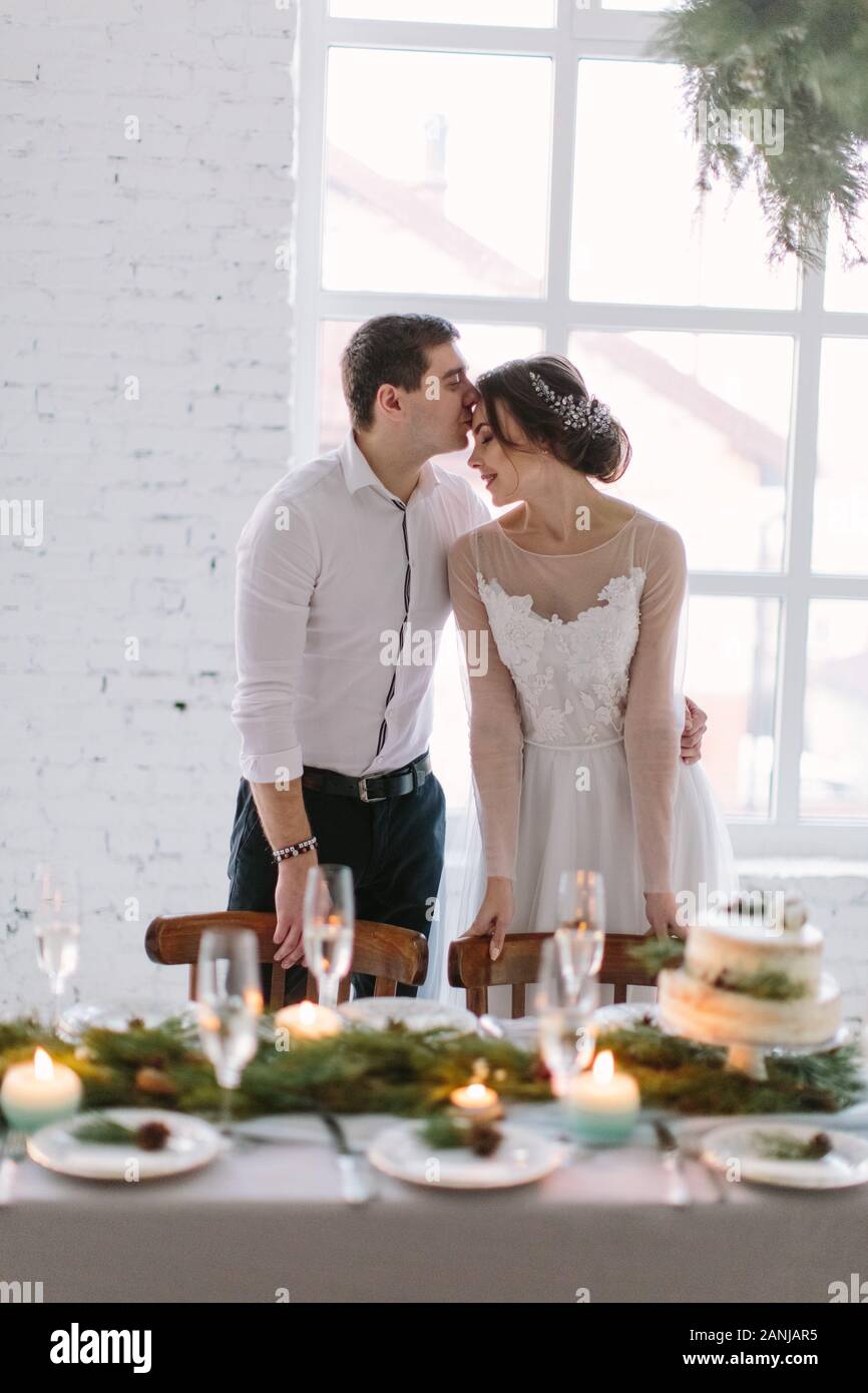 Emotional beautiful newlywed couple smiling, kissing and hugging at ...