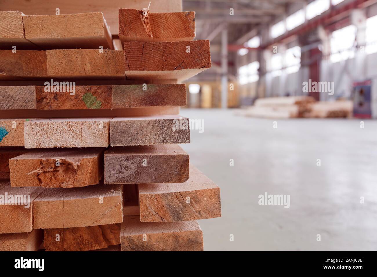 Warehouse or factory for sawing boards on sawmill indoors. Wood timber ...