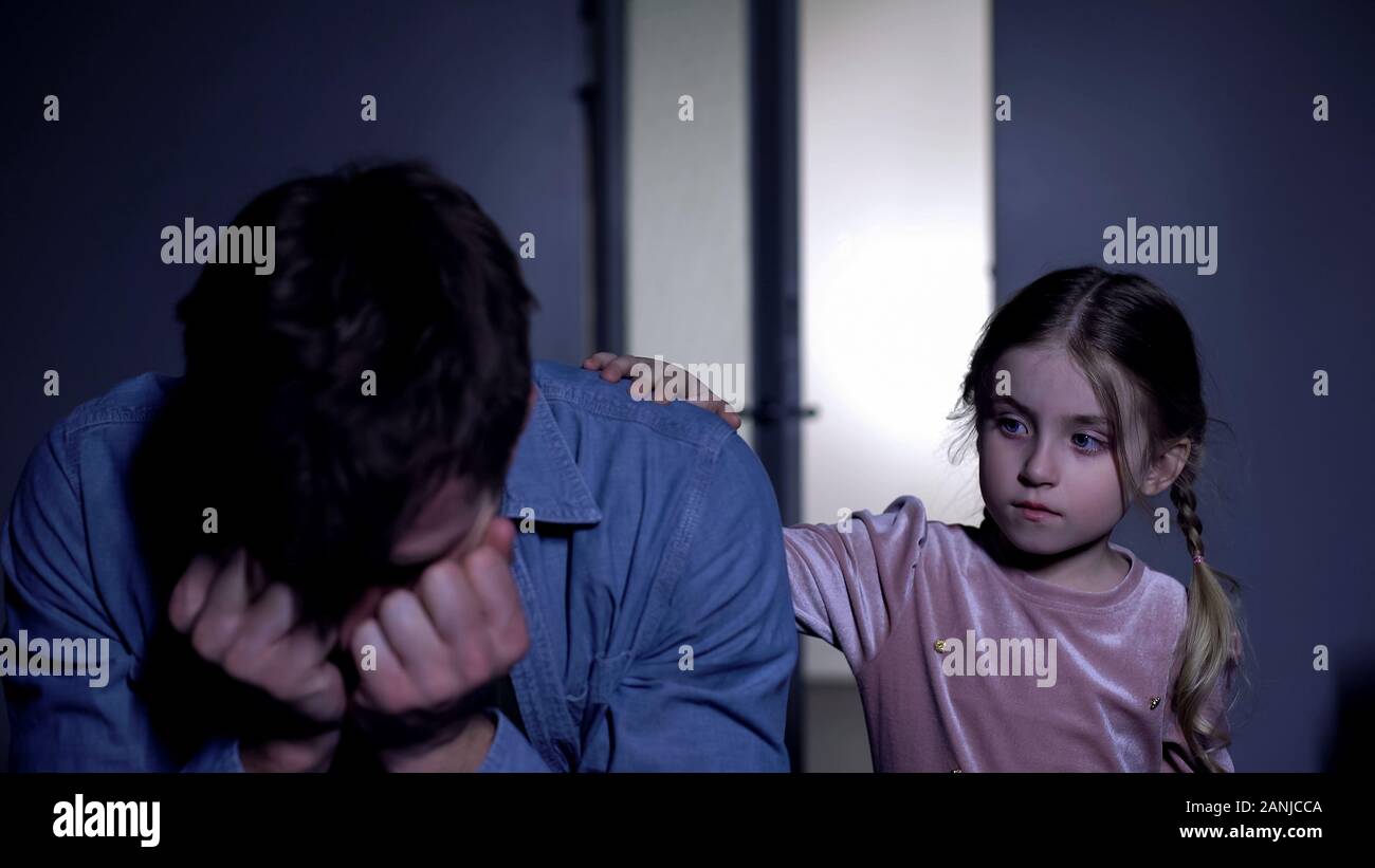 Sorrowful man crying in despair, little daughter comforting dad, family ...