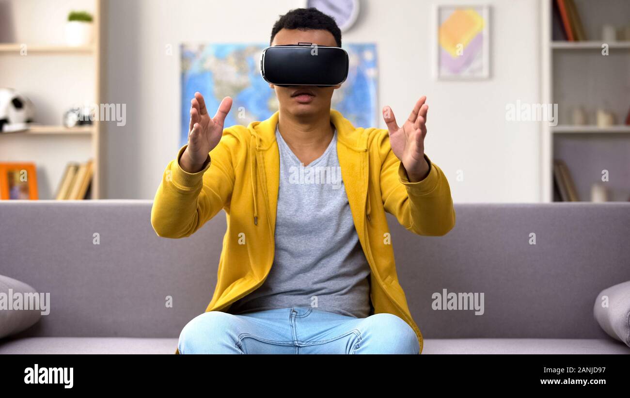Afro-American student in VR headset preparing presentation, modern ...