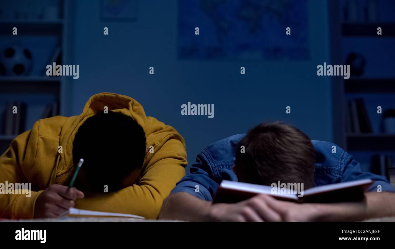 Sleepy overloaded multiracial student falling asleep at night before ...
