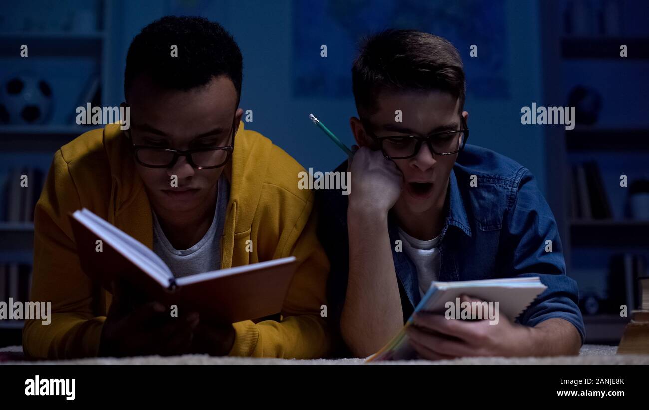 Afro-american and caucasian students trying to solve difficult ...