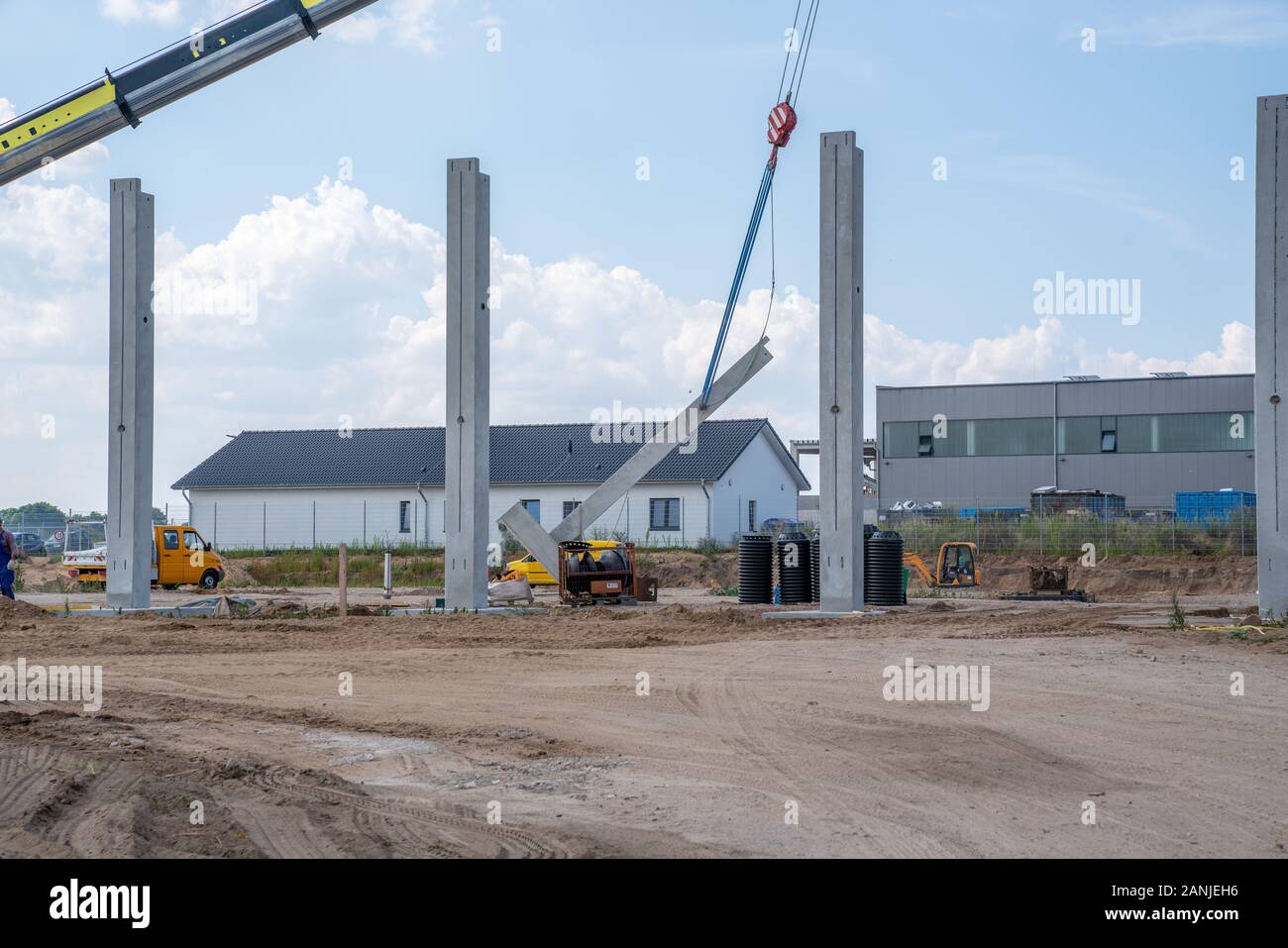 on a construction site, concrete columns for a factory building are ...