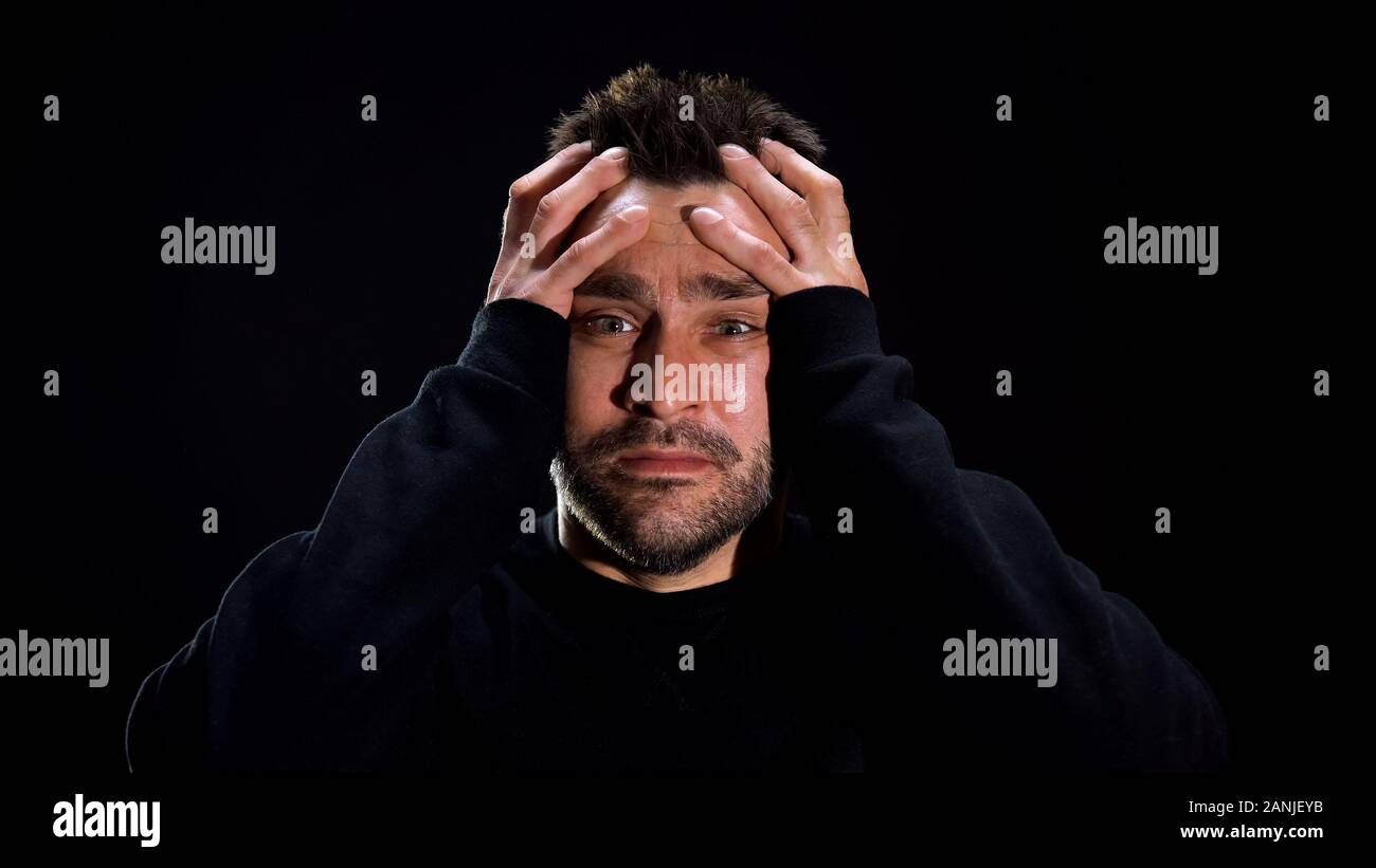 Terrified caucasian man covering head by hands, mental disease ...