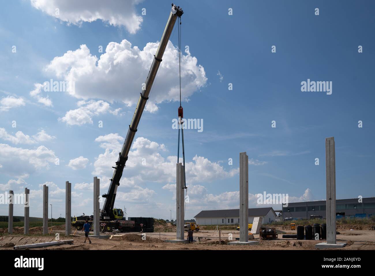 on a construction site, concrete columns for a factory building are ...