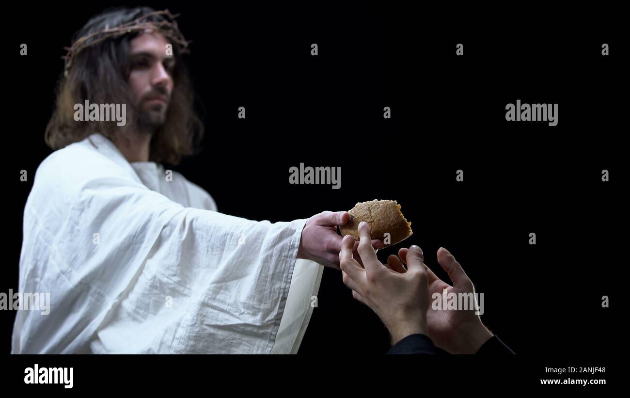 Jesus giving bread to poor man on black background, biblical history ...