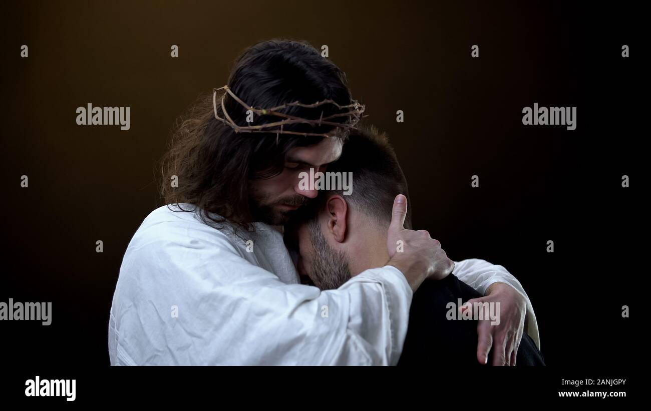 Savior in crown of thrones hugging desperate male, religious peace ...
