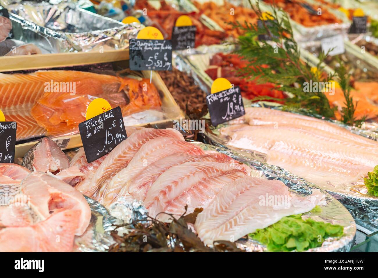 Raw perched fish fillet at the fish market with price tags. Large ...