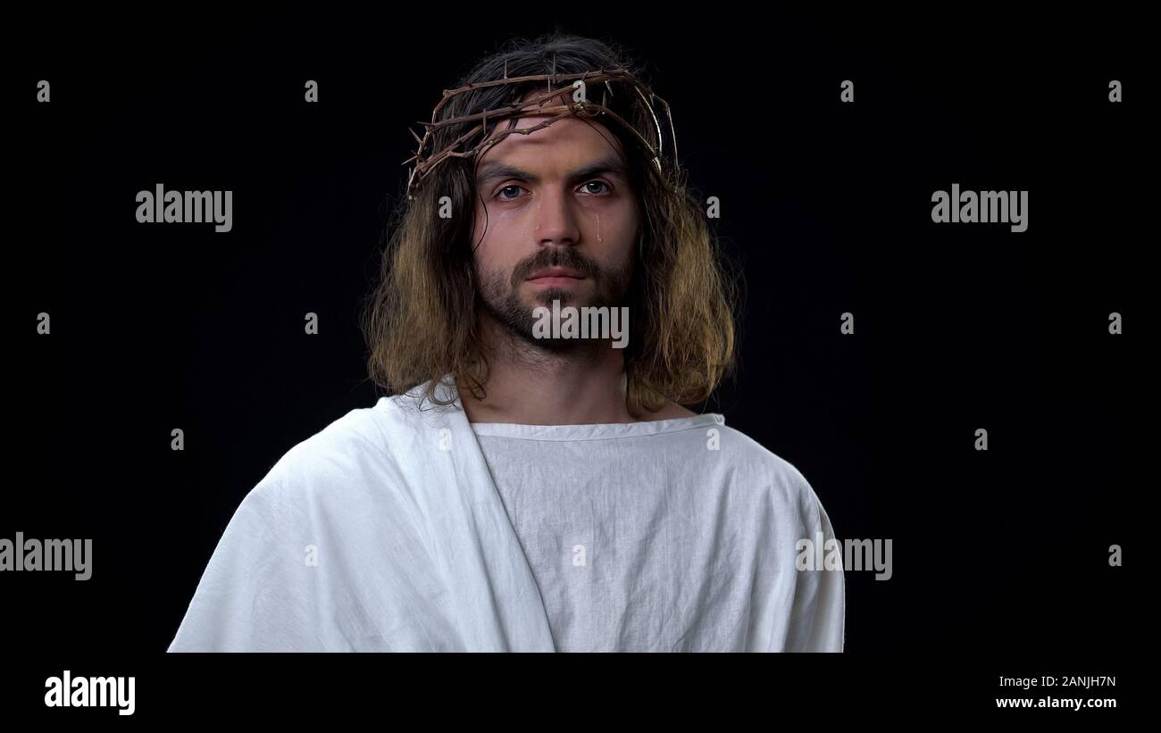 Crying savior in crown of thorns and white cloth, suffering for human ...