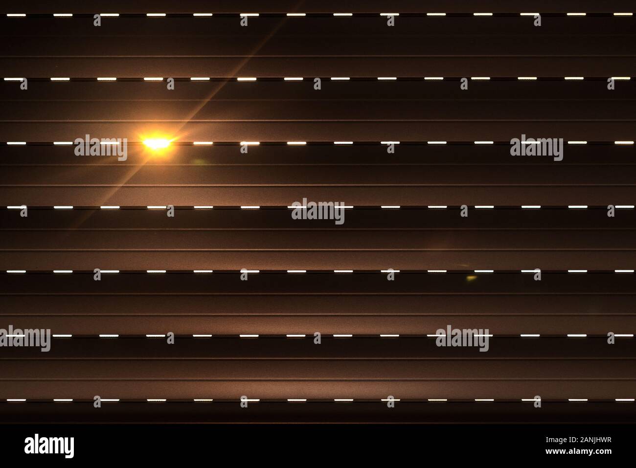 Shutters - blinds with sunlight in the morning. Dark wooden window with ...