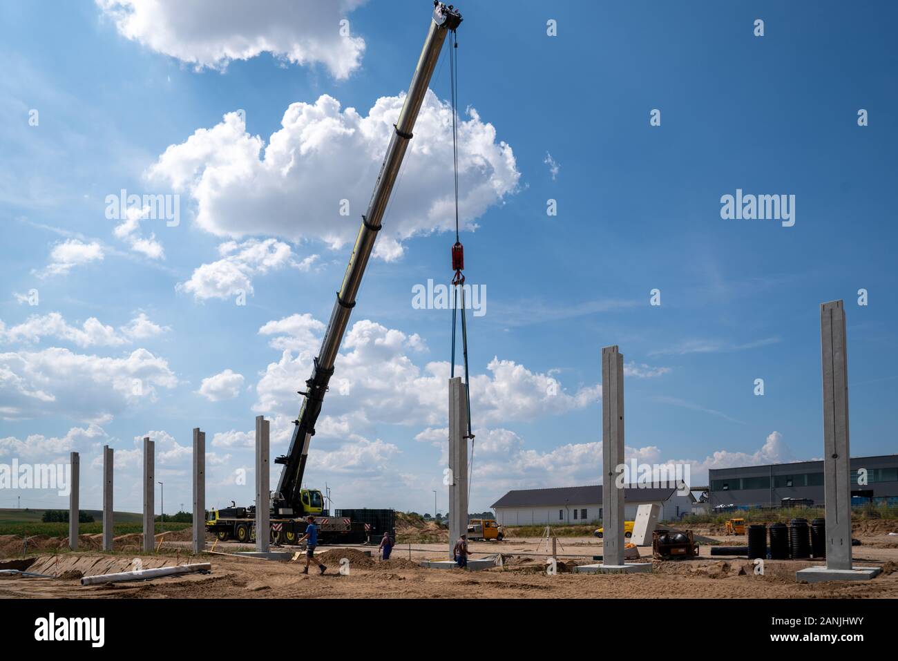 on a construction site, concrete columns for a factory building are ...