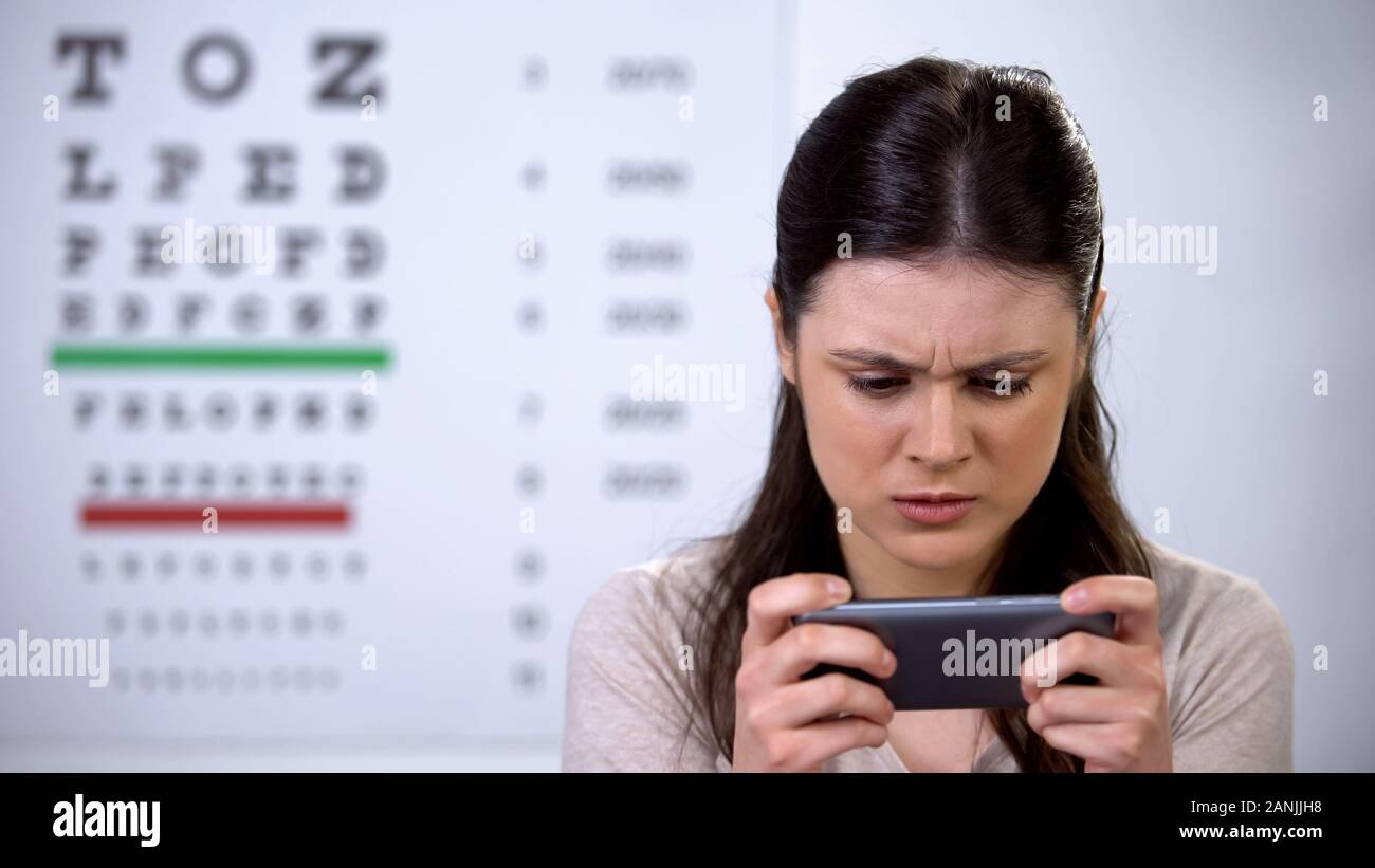 Addicted female playing video game on smartphone, harmful impact on ...