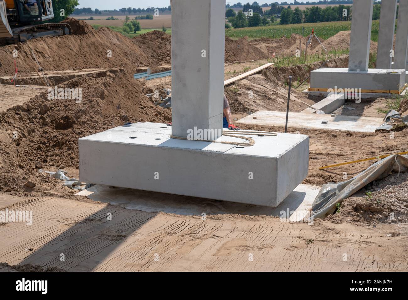 on a construction site, concrete columns for a factory building are ...
