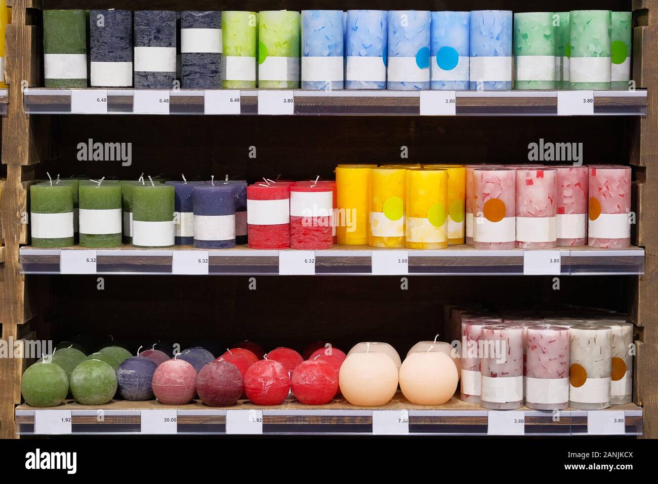 Candles for sale in a interior decorating store. oloured variety paraffin candles in cozy candle shop Stock Photo Alamy