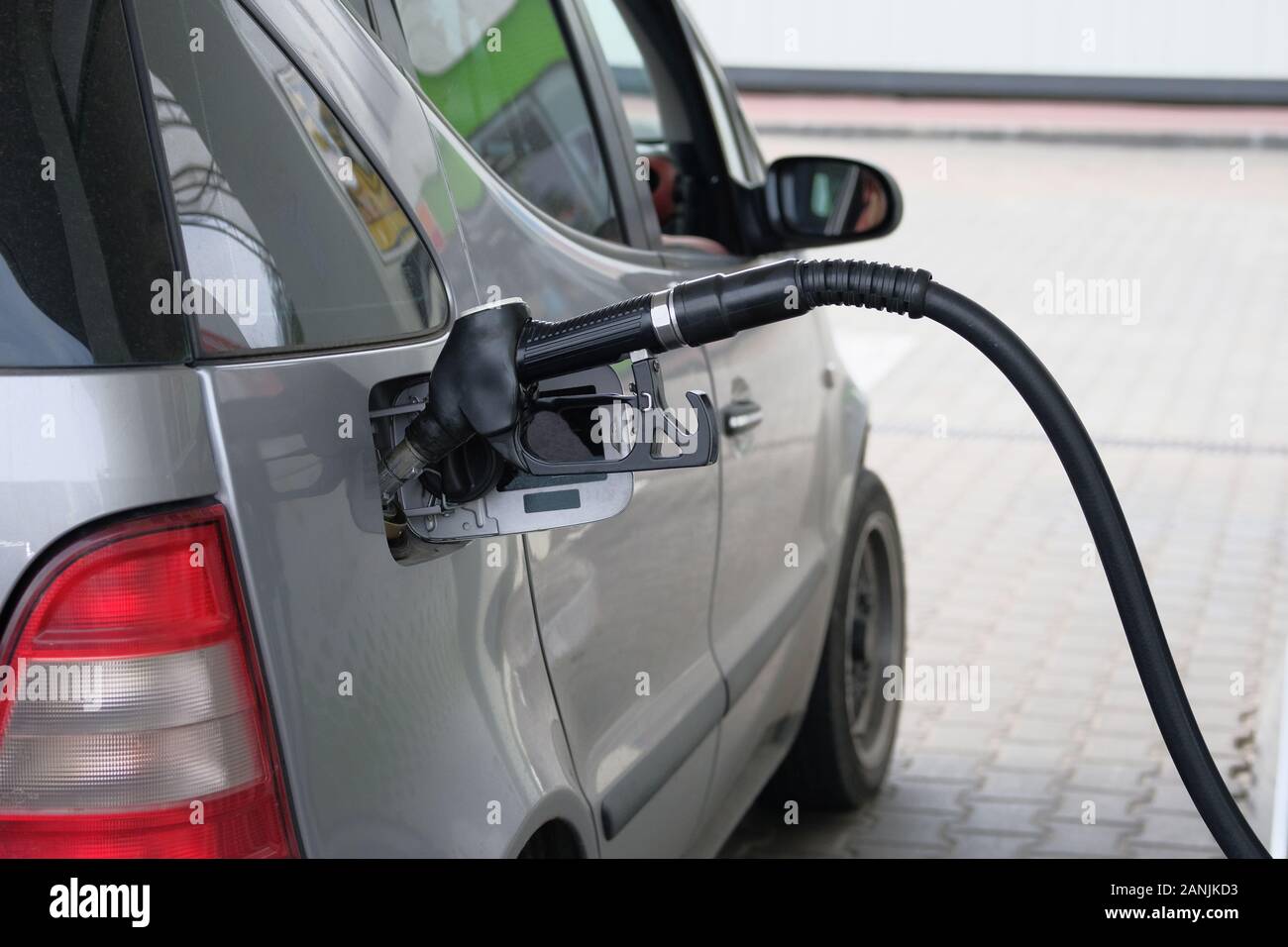 Car fill with gasoline at gas station. Close up of pumping gasoline ...