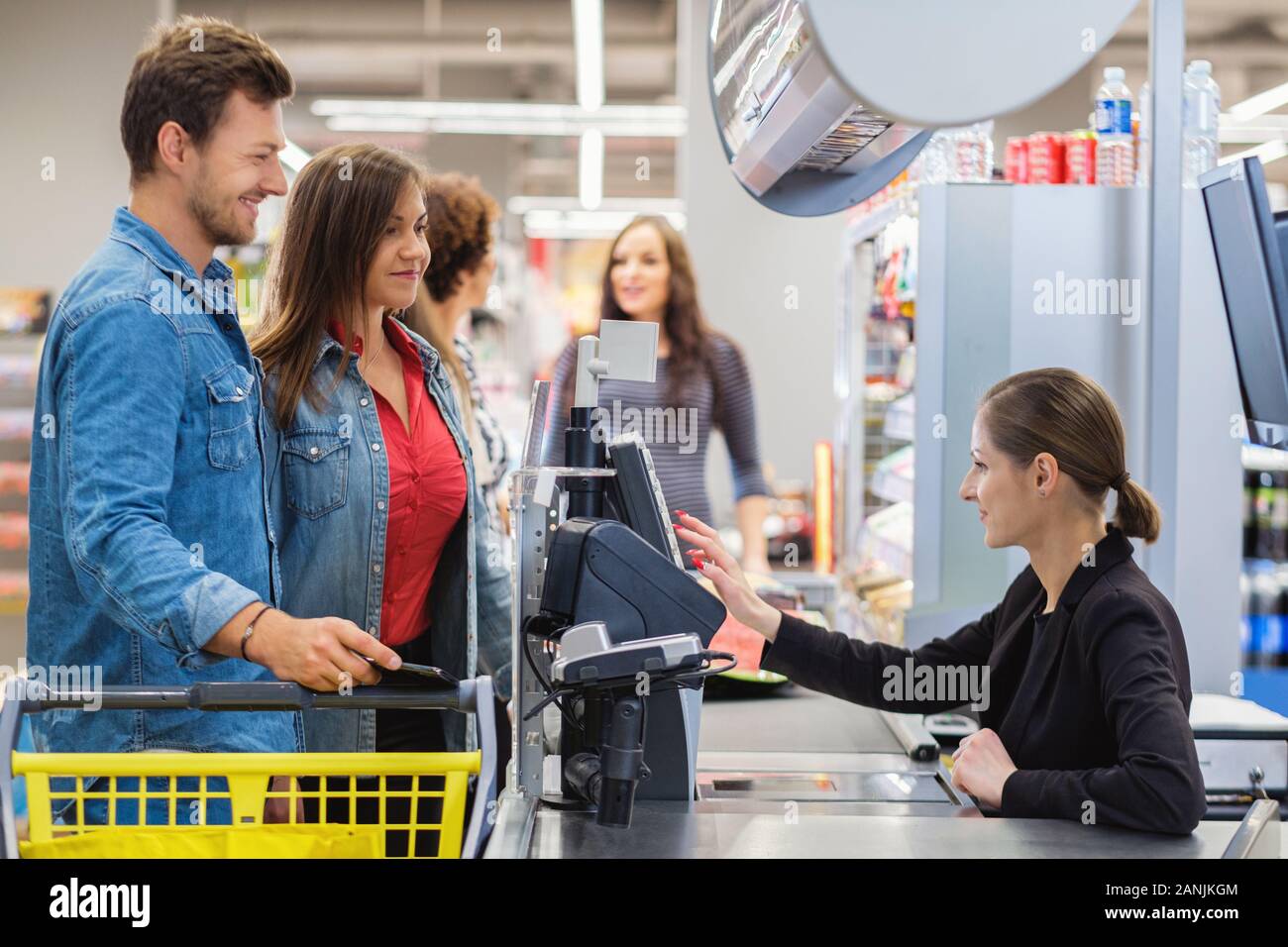 Couple buying goods in a grocery store Stock Photo - Alamy