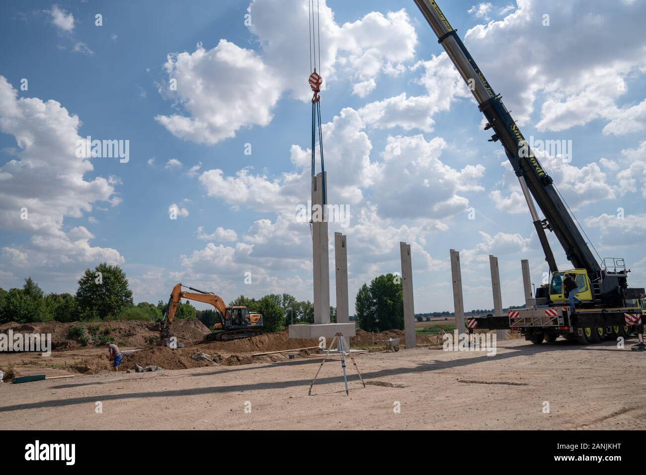on a construction site, concrete columns for a factory building are ...