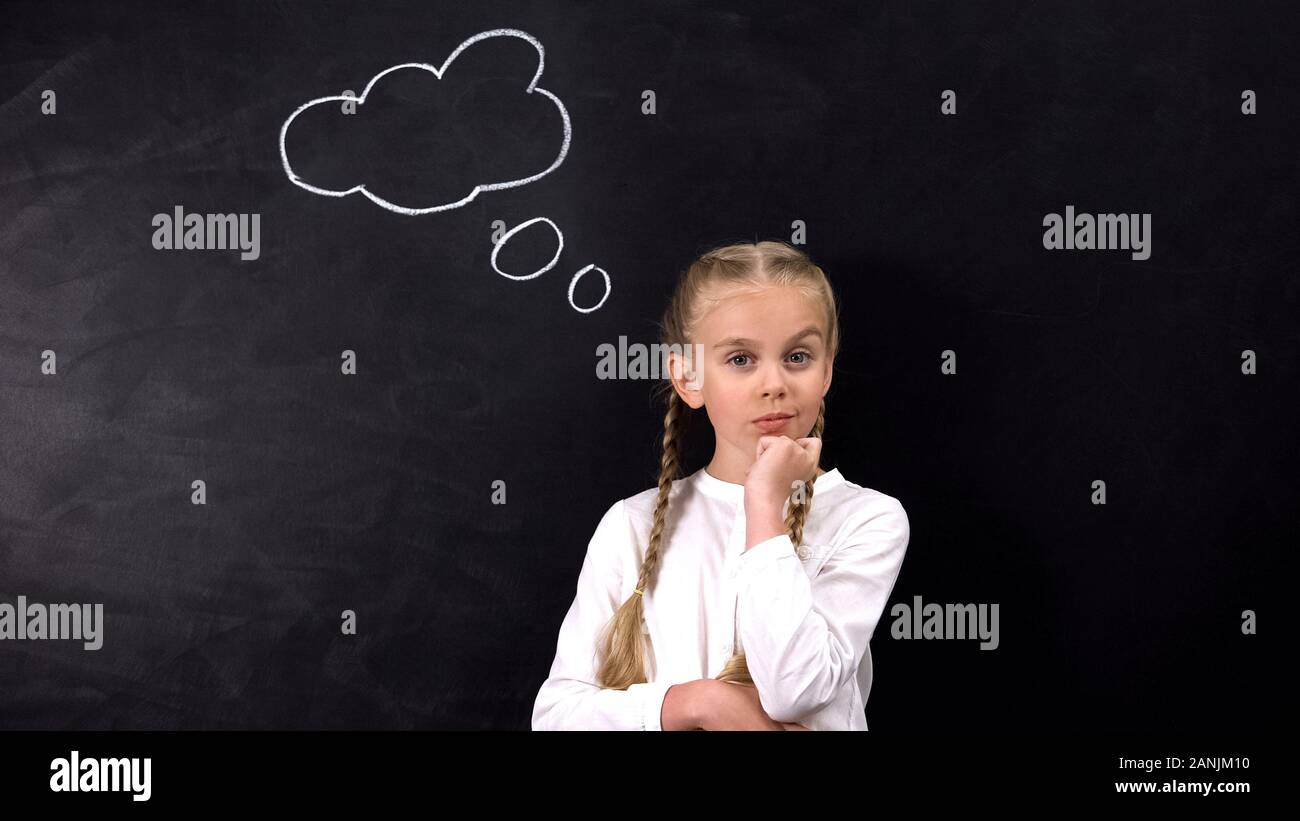 Tricky student thinking about prank, idea sign painted on blackboard ...