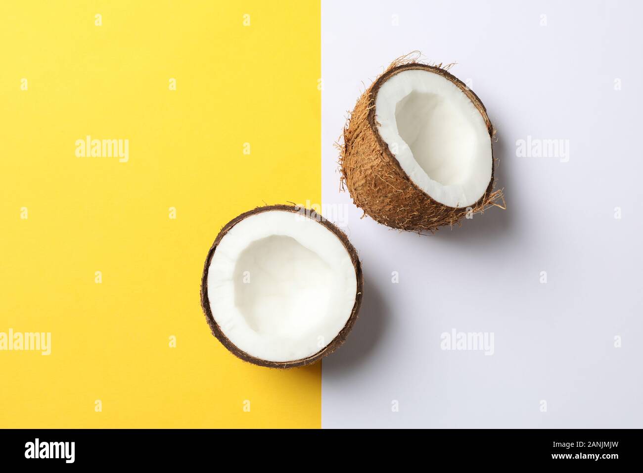 Coconut halves on two tone background, space for text Stock Photo - Alamy