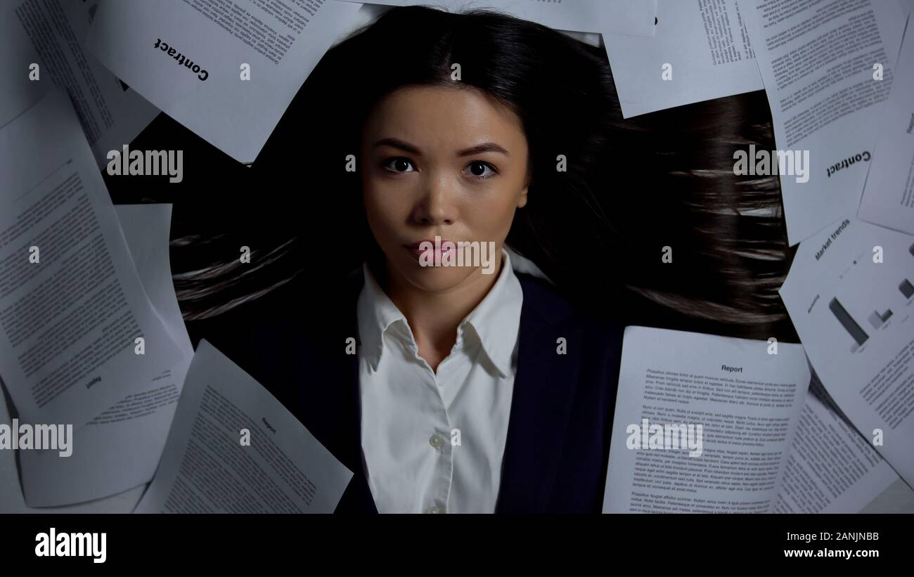 Overload businesswoman lying among pile of documents, overworking ...