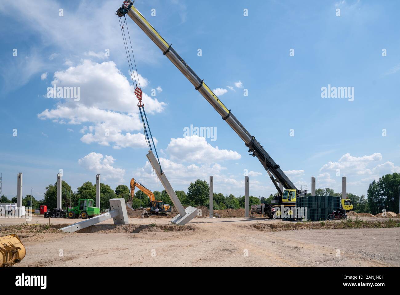 on a construction site, concrete columns for a factory building are ...