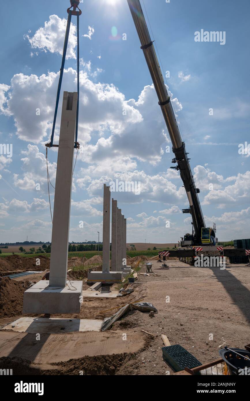 on a construction site, concrete columns for a factory building are ...