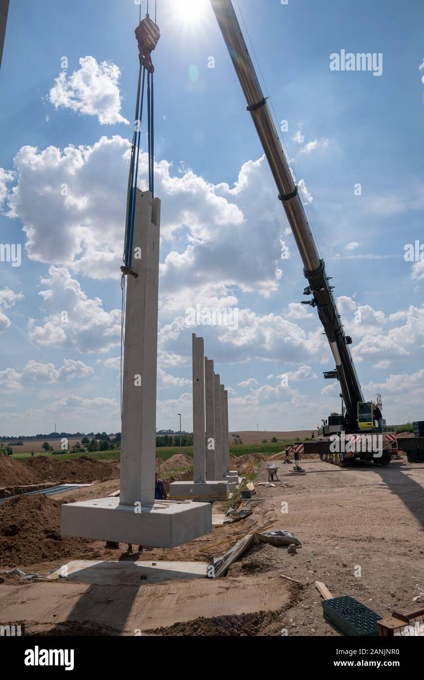 on a construction site, concrete columns for a factory building are ...