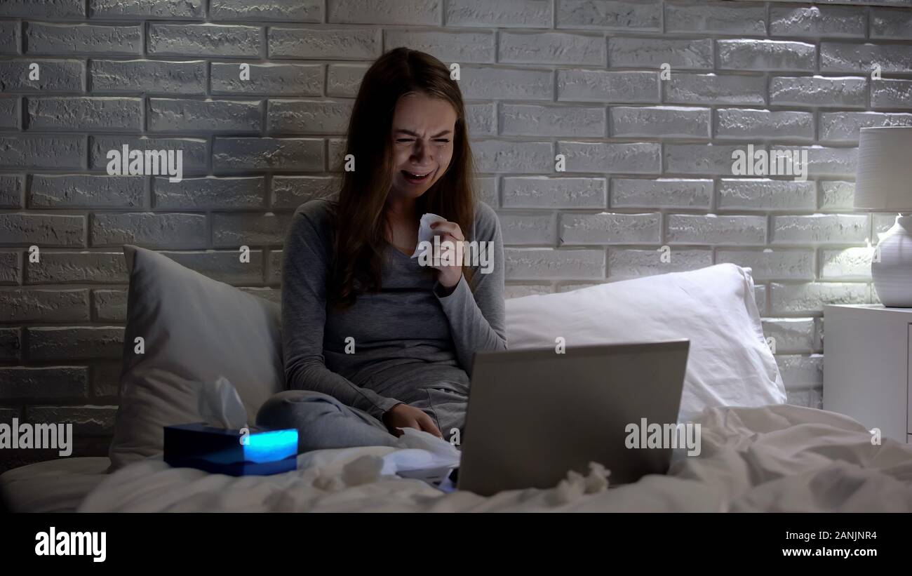 Crying while watching laptop hi-res stock photography and images - Alamy