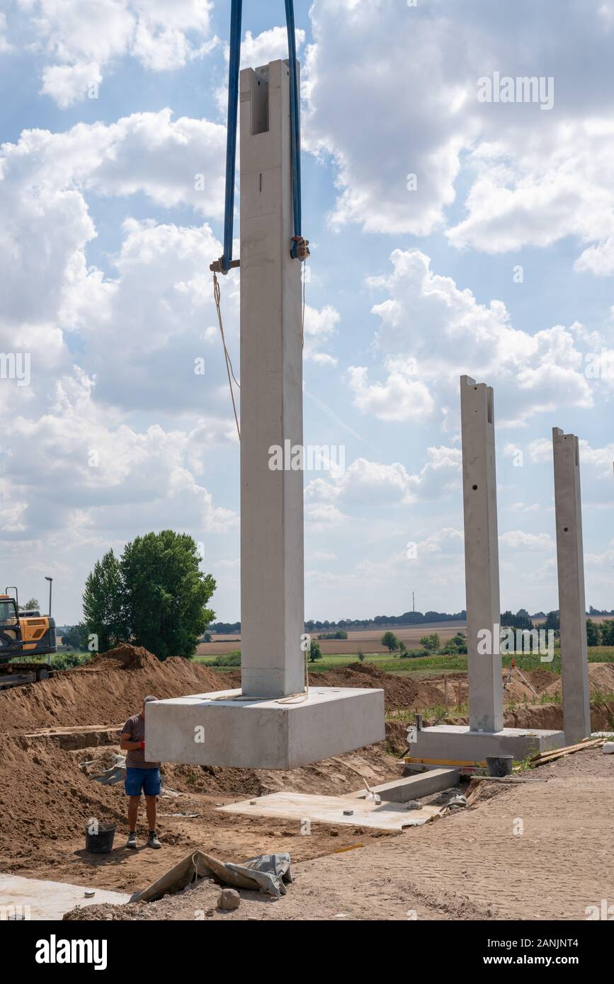 on a construction site, concrete columns for a factory building are ...