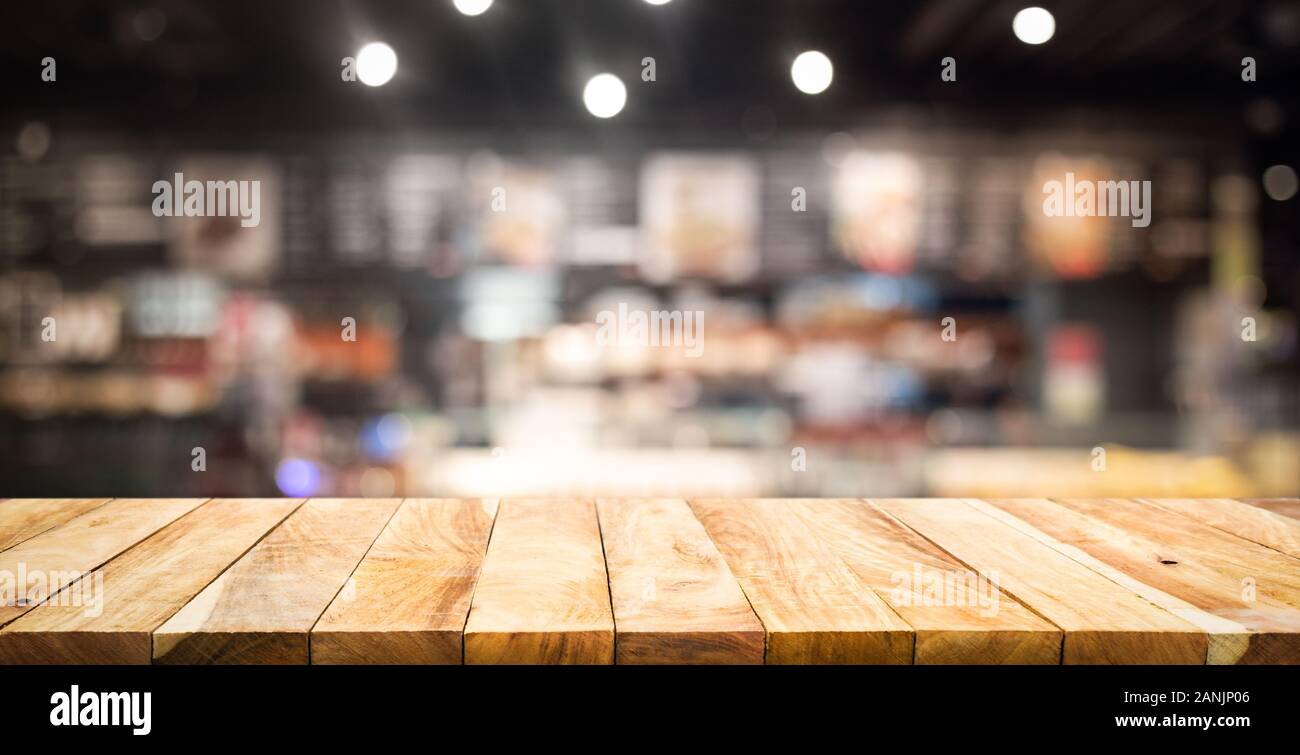 Wood texture table top (counter bar) with blur cafe,restaurant ...