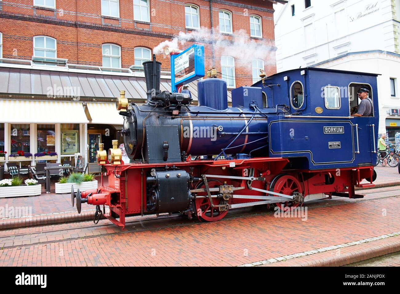 Blue narrow gauge steam locomotive at the train station in the town ...