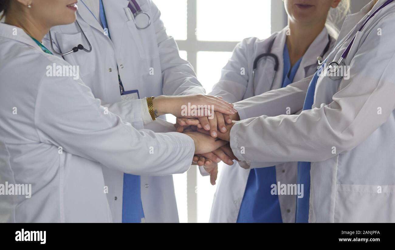Team of medical workers holding hands together indoors, above view. Unity concept Stock Photo ...